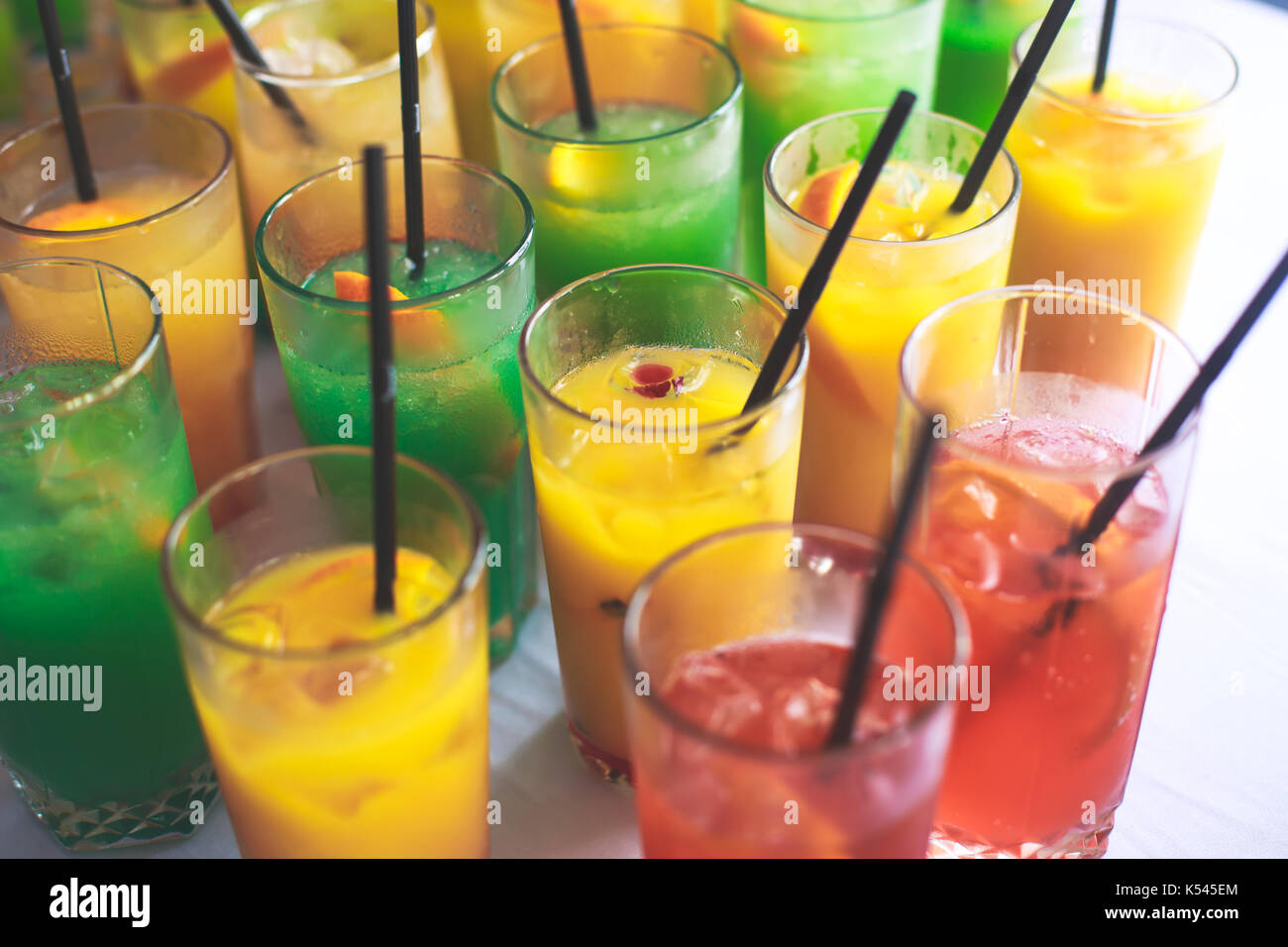 Beautiful line of different coloured alcohol cocktails on a open air ...