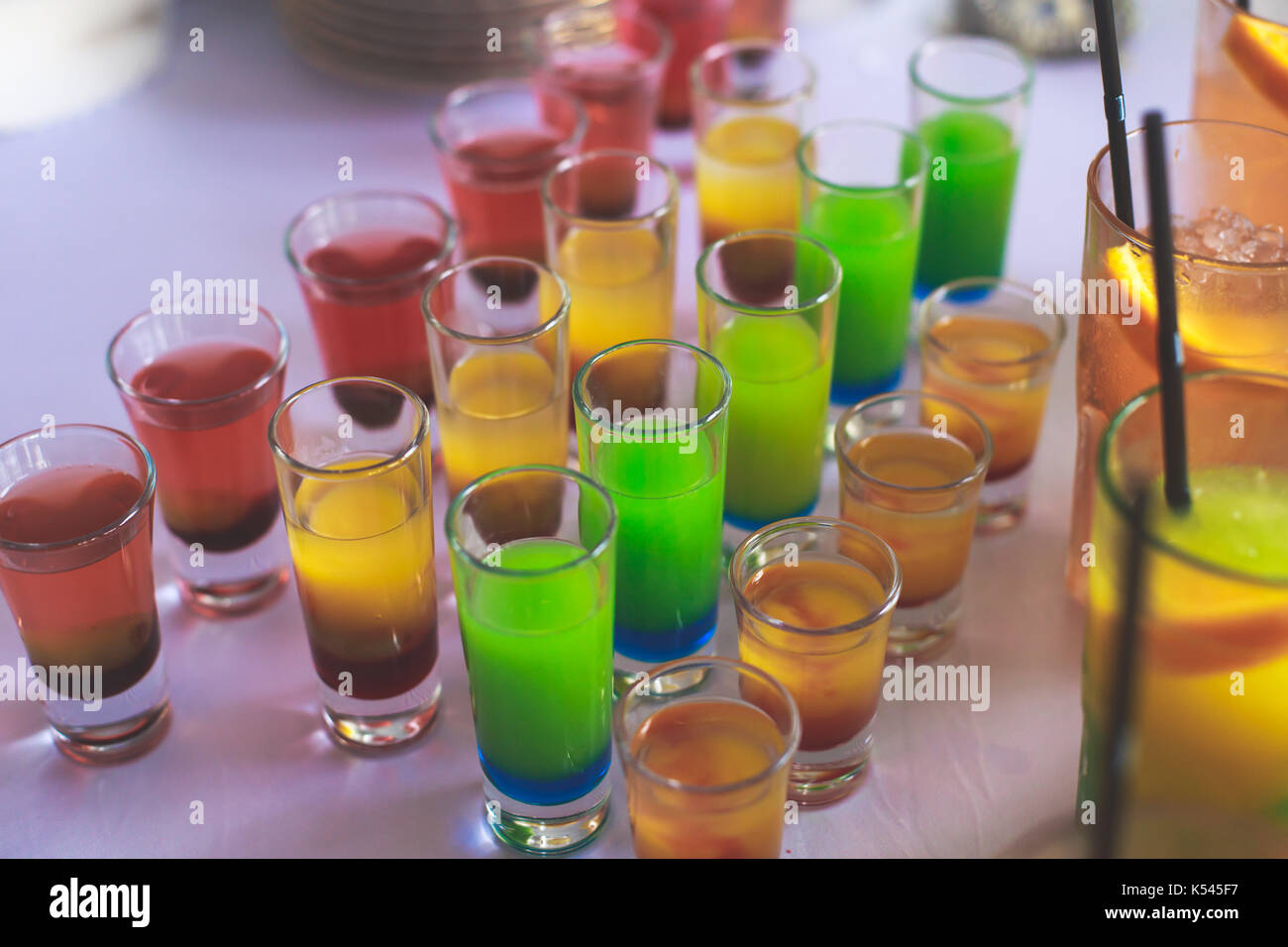 Beautiful line of different coloured alcohol cocktails on a open air ...