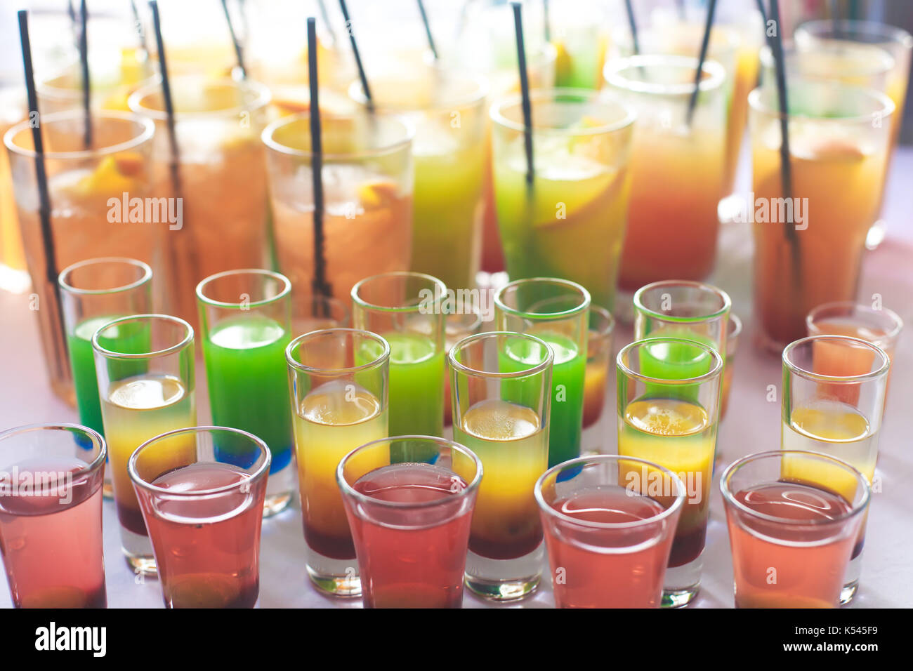 Beautiful line of different coloured alcohol cocktails on a open air ...