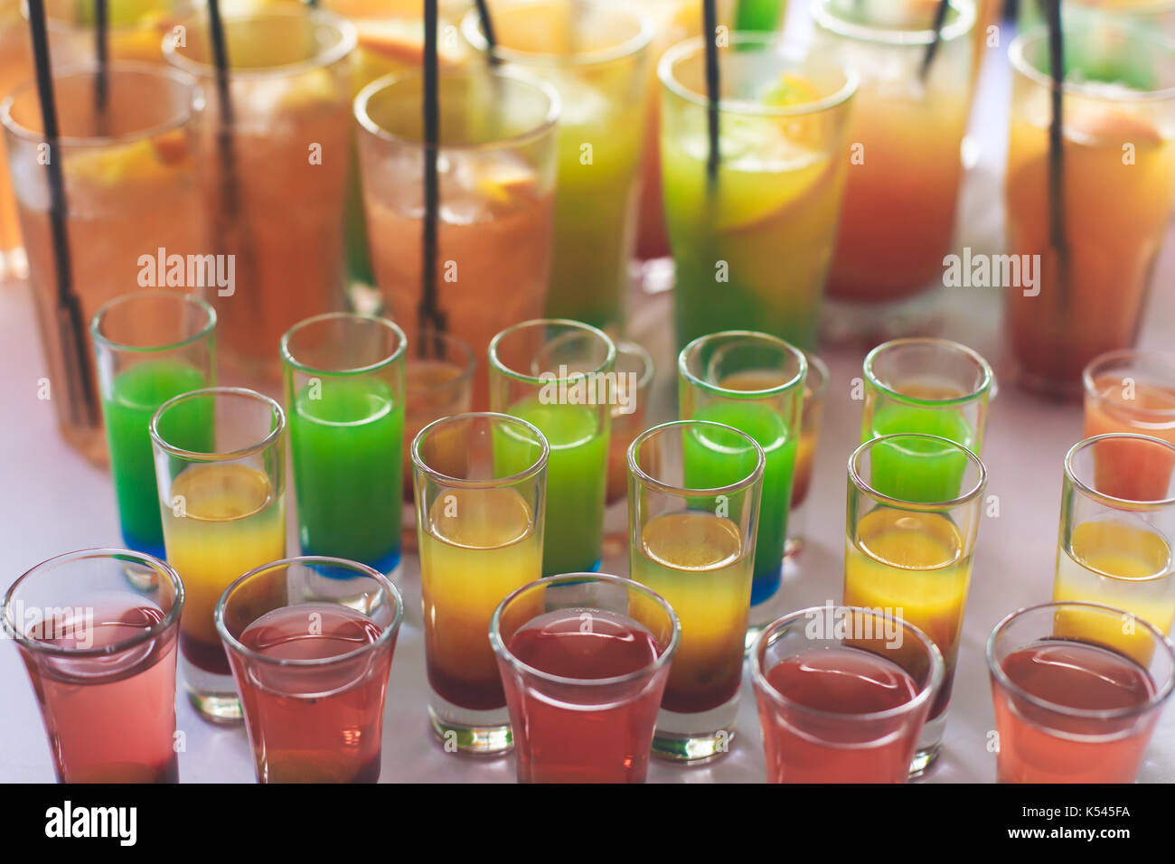 Beautiful line of different coloured alcohol cocktails on a open air ...