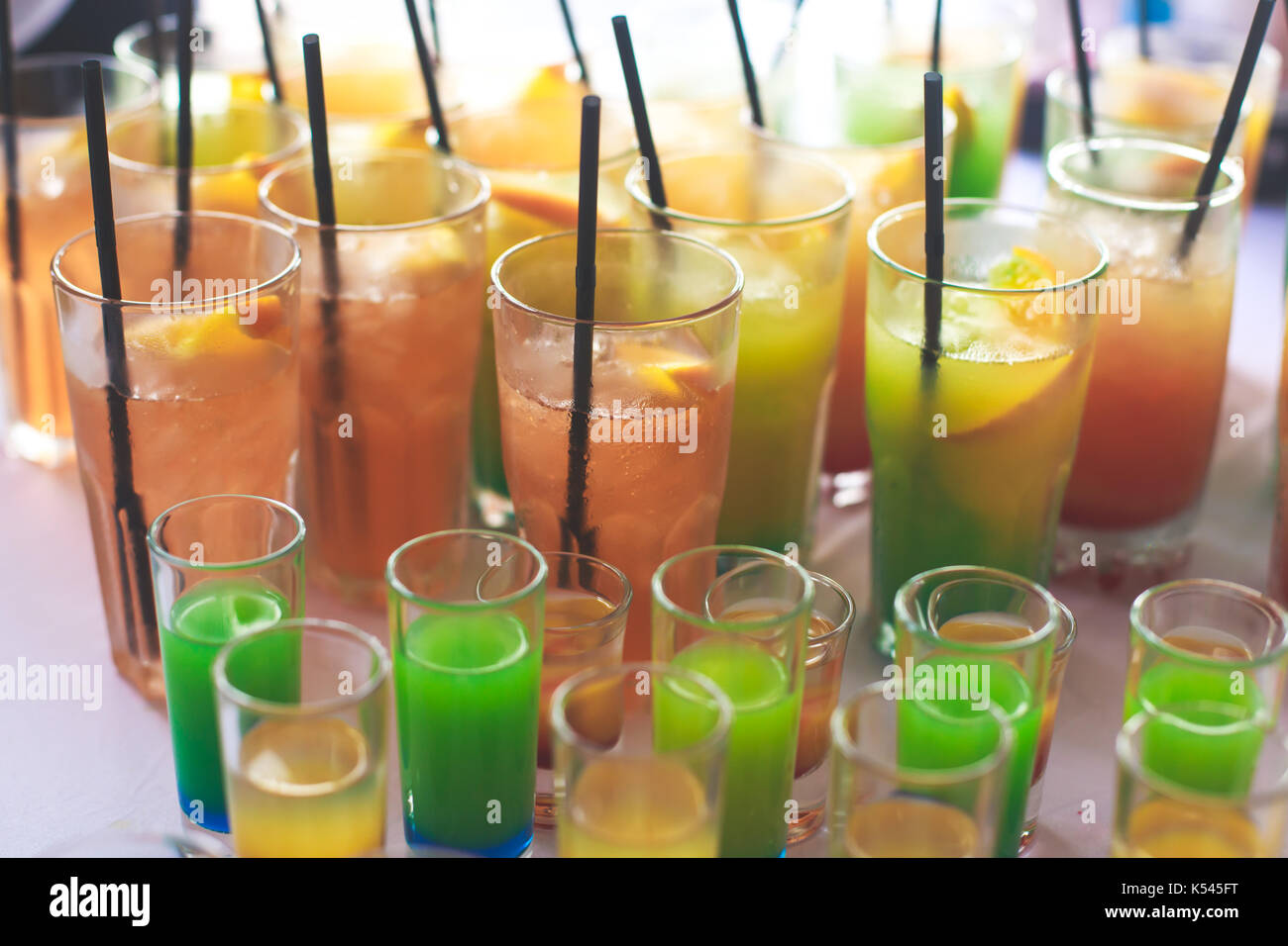 Beautiful line of different coloured alcohol cocktails on a open air ...