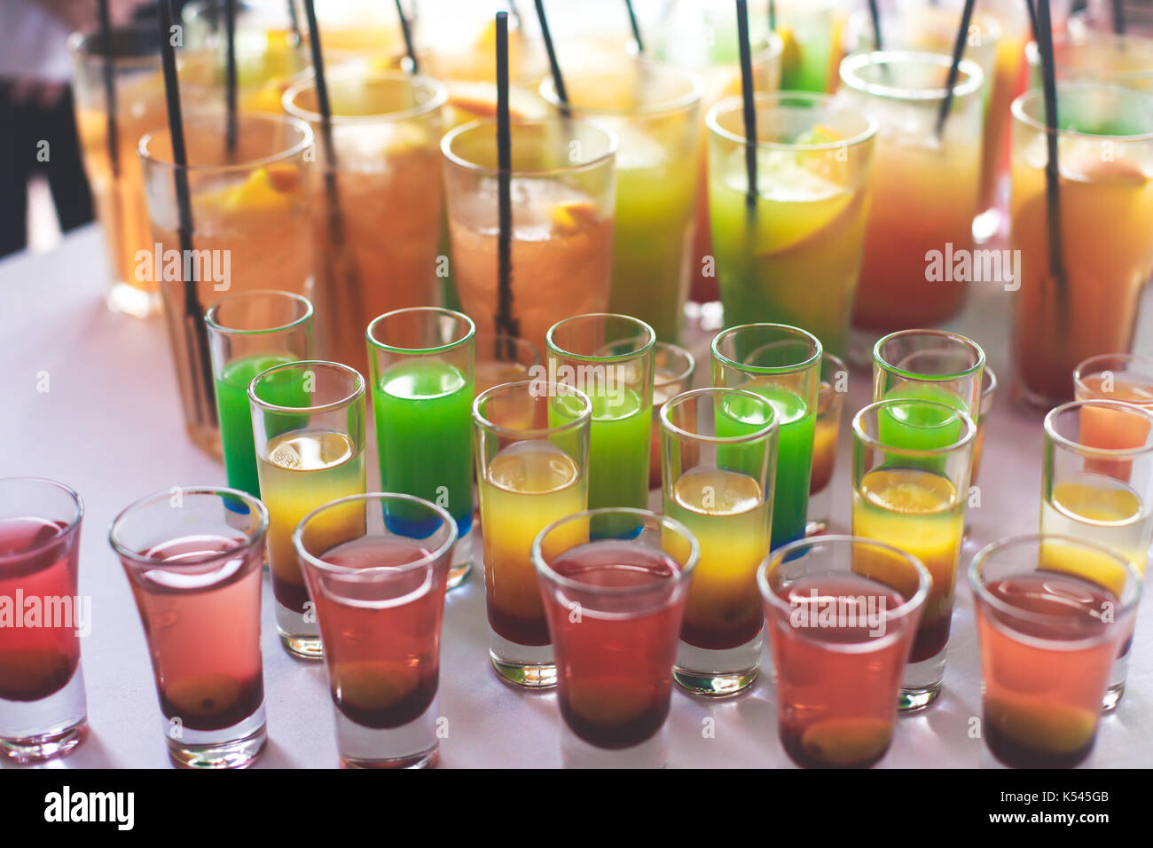Beautiful line of different coloured alcohol cocktails on a open air ...