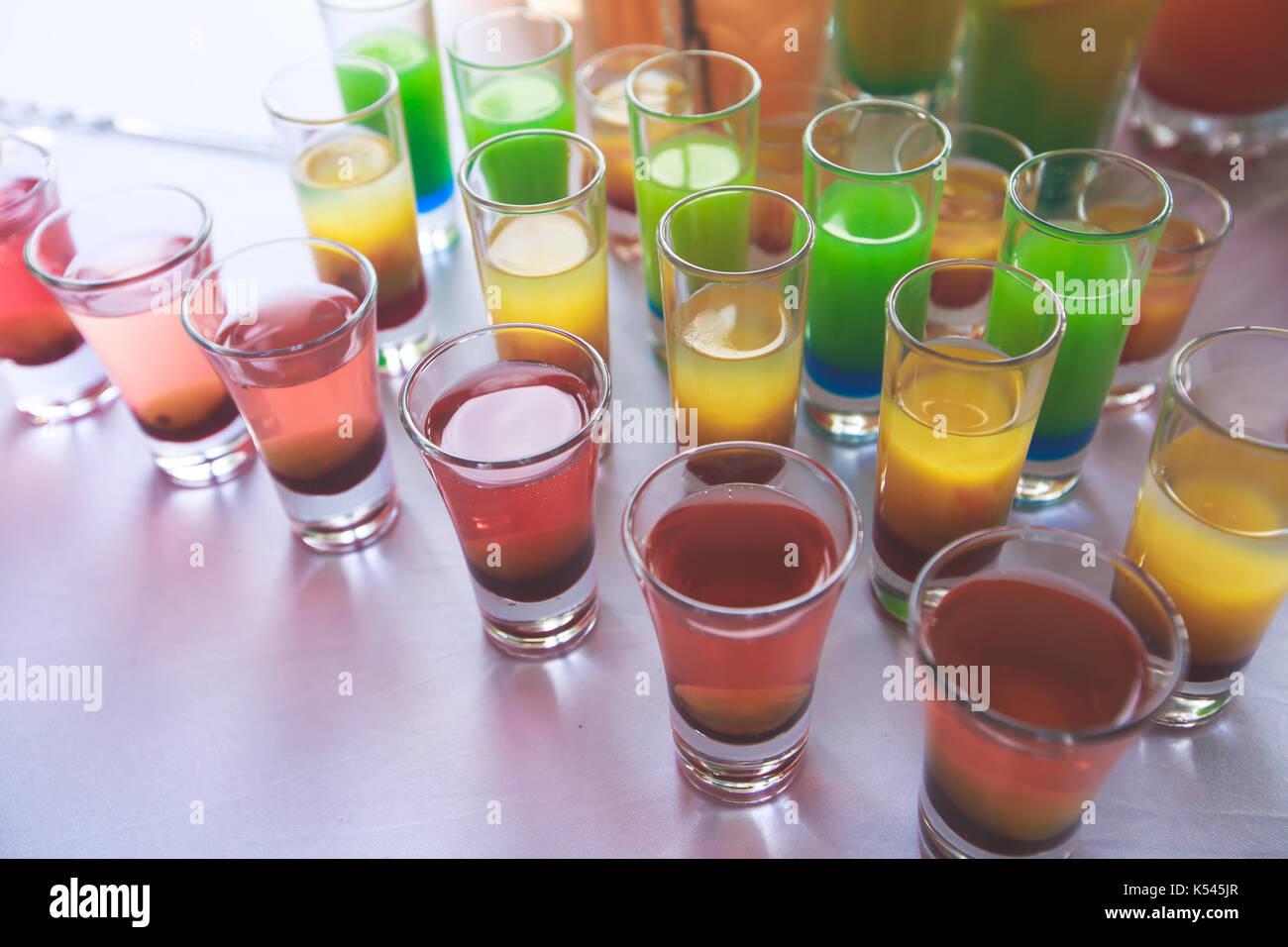 Beautiful line of different coloured alcohol cocktails on a open air ...