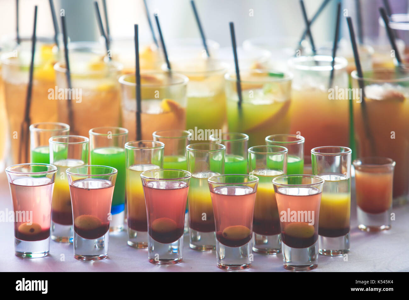 Beautiful line of different coloured alcohol cocktails on a open air ...