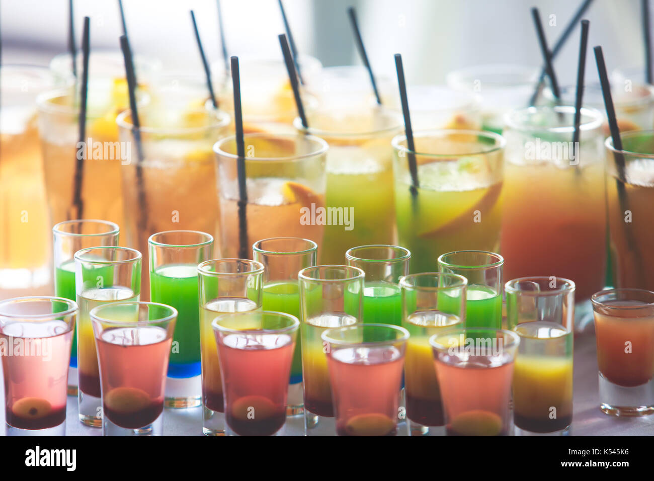 Beautiful line of different coloured alcohol cocktails on a open air ...