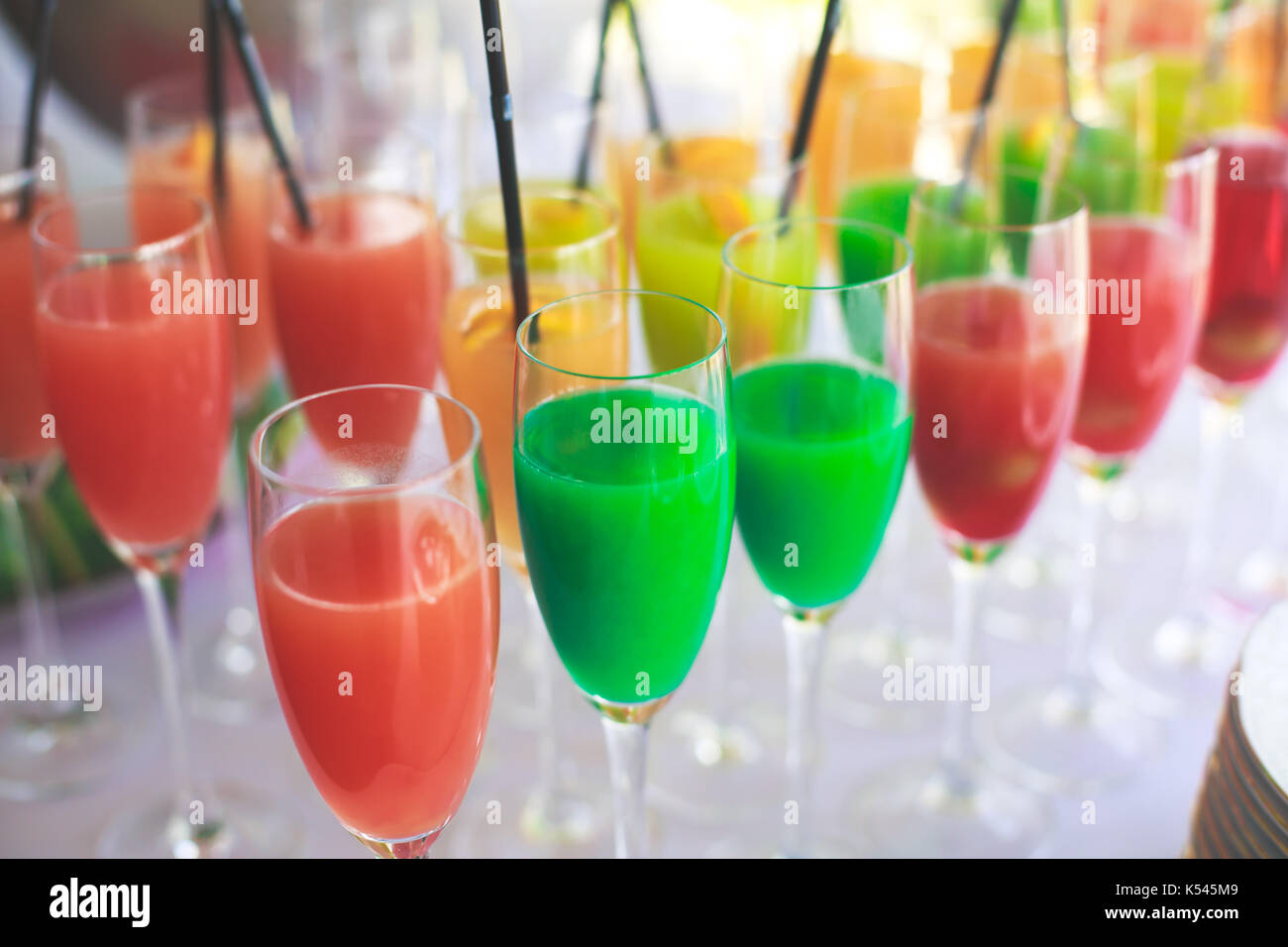 Beautiful line of different coloured alcohol cocktails on a open air ...