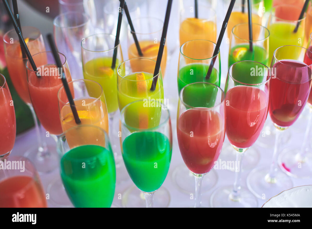 Beautiful line of different coloured alcohol cocktails on a open air ...