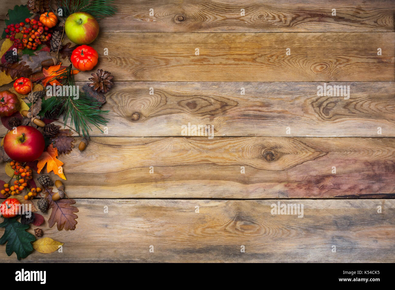 Rustic Thanksgiving background with pumpkin, apples and cones on the ...