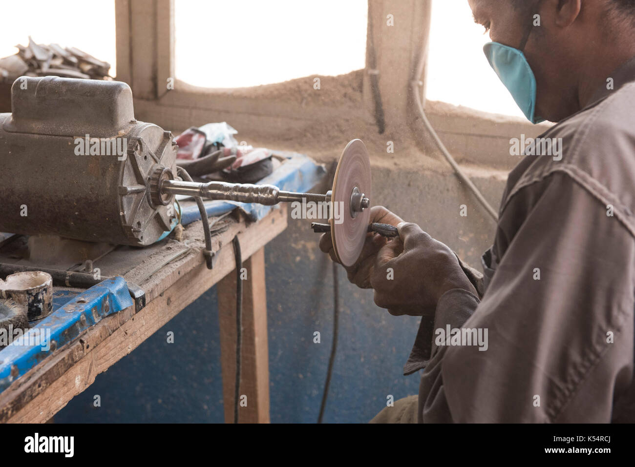Artisan at work in zebu horn craft workshop, Maminirina cornet des zebu ...