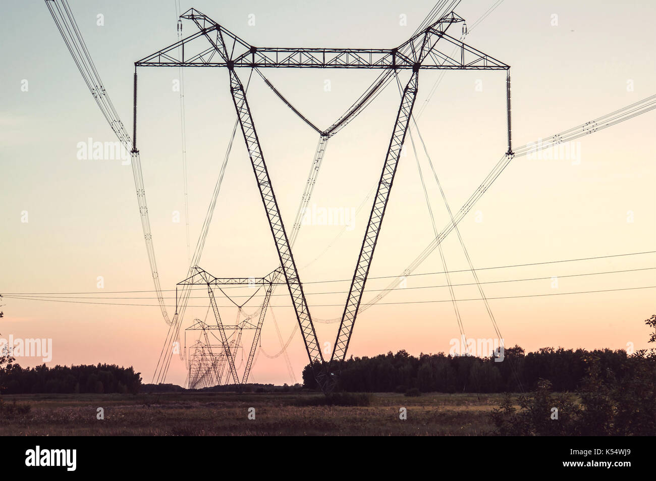 Pylon and transmission power line in sunset Stock Photo - Alamy