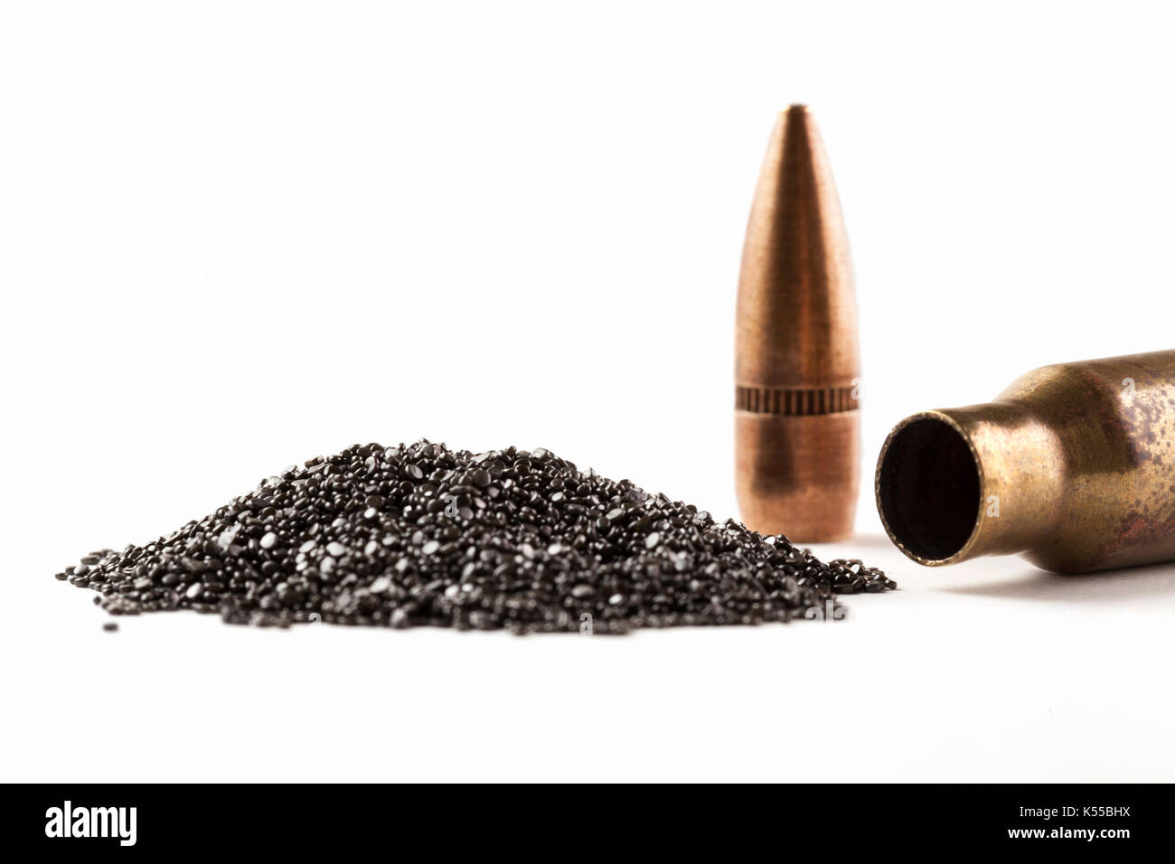 Rifle Bullet and Shel near pile of gunpowder isolated on white Stock ...