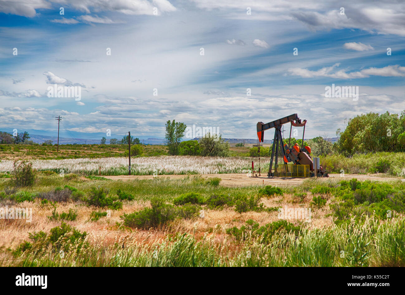 An oil well in the Wyoming plains pulls oil and gas from the ground ...