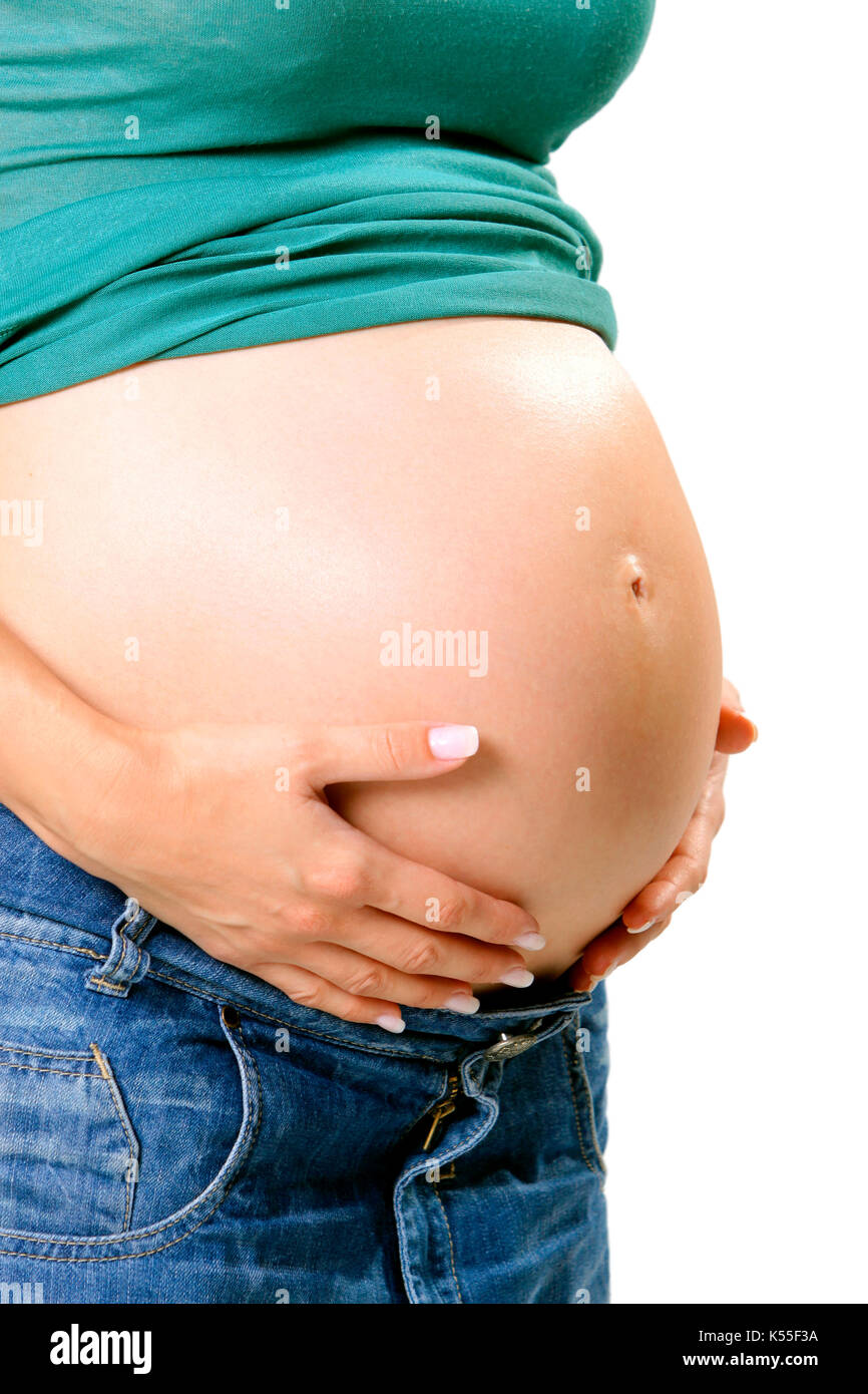 Closeup of a pregnant young woman's belly Stock Photo - Alamy
