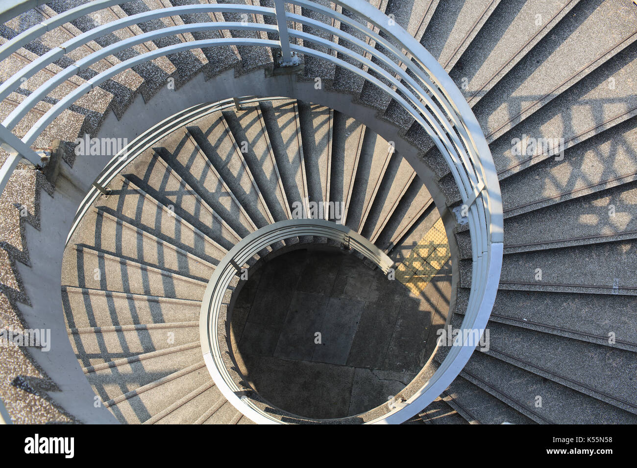 long spiral stair of footbridge with the sun ray light and shadow in ...