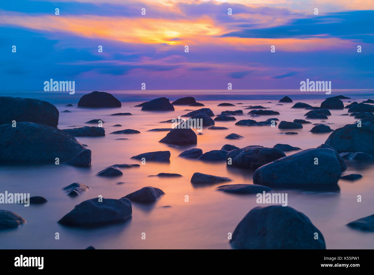 Moody seascape background at sunset, rocks in the Irish Sea at Seascale ...
