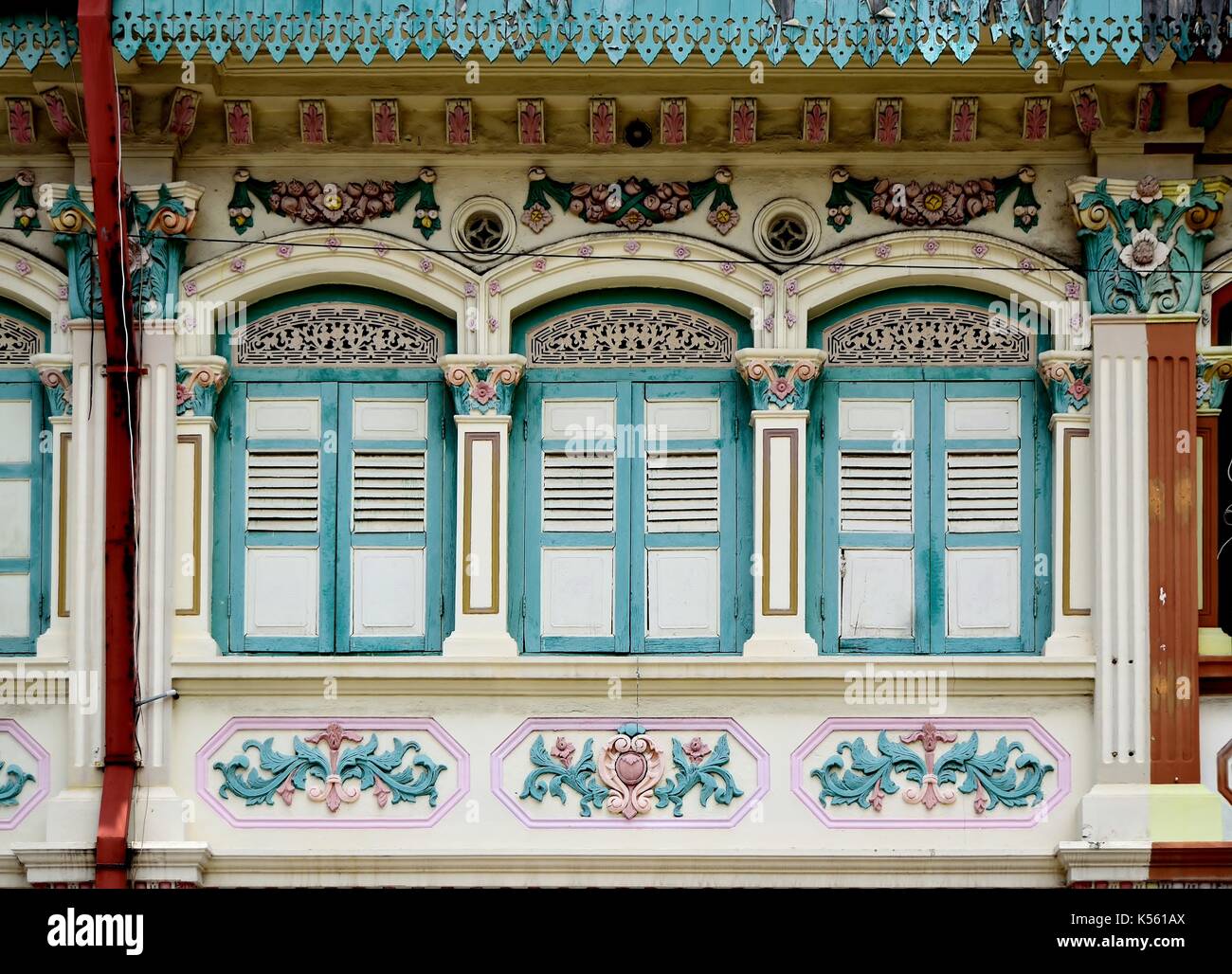 Traditional shop house exterior with green and white wooden louvered ...