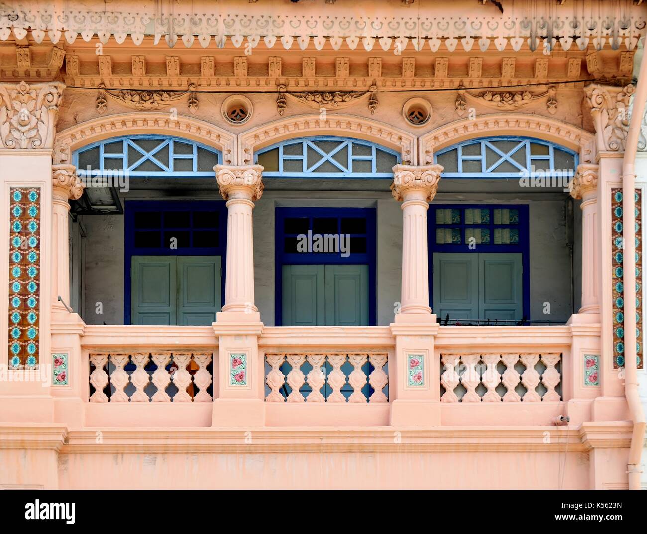 Traditional shop house exterior with arched windows and ornate stone ...