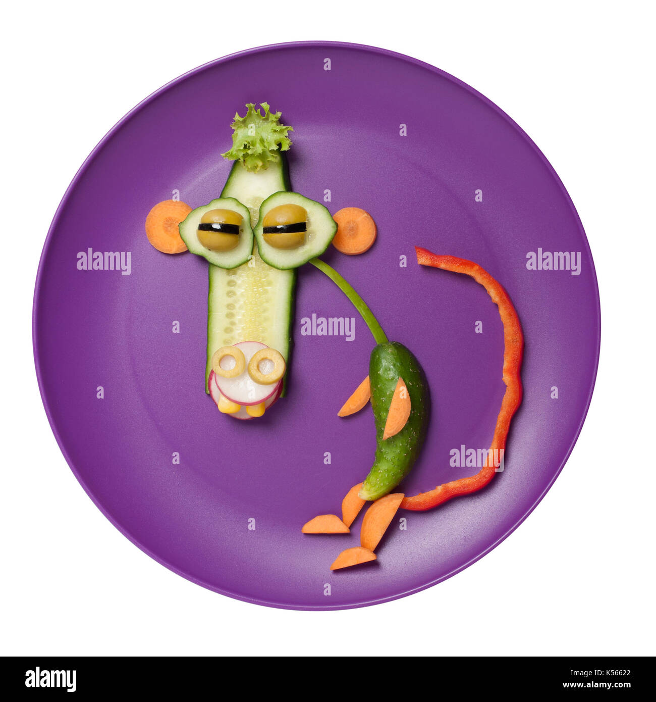 Monkey made with vegetables on purple plate Stock Photo - Alamy