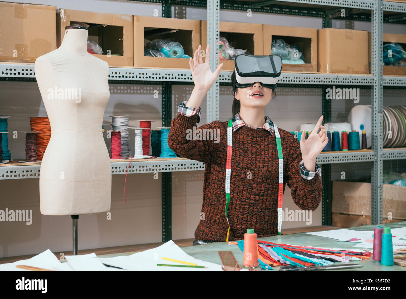 happy attractive clothing factory woman worker wearing virtual reality ...