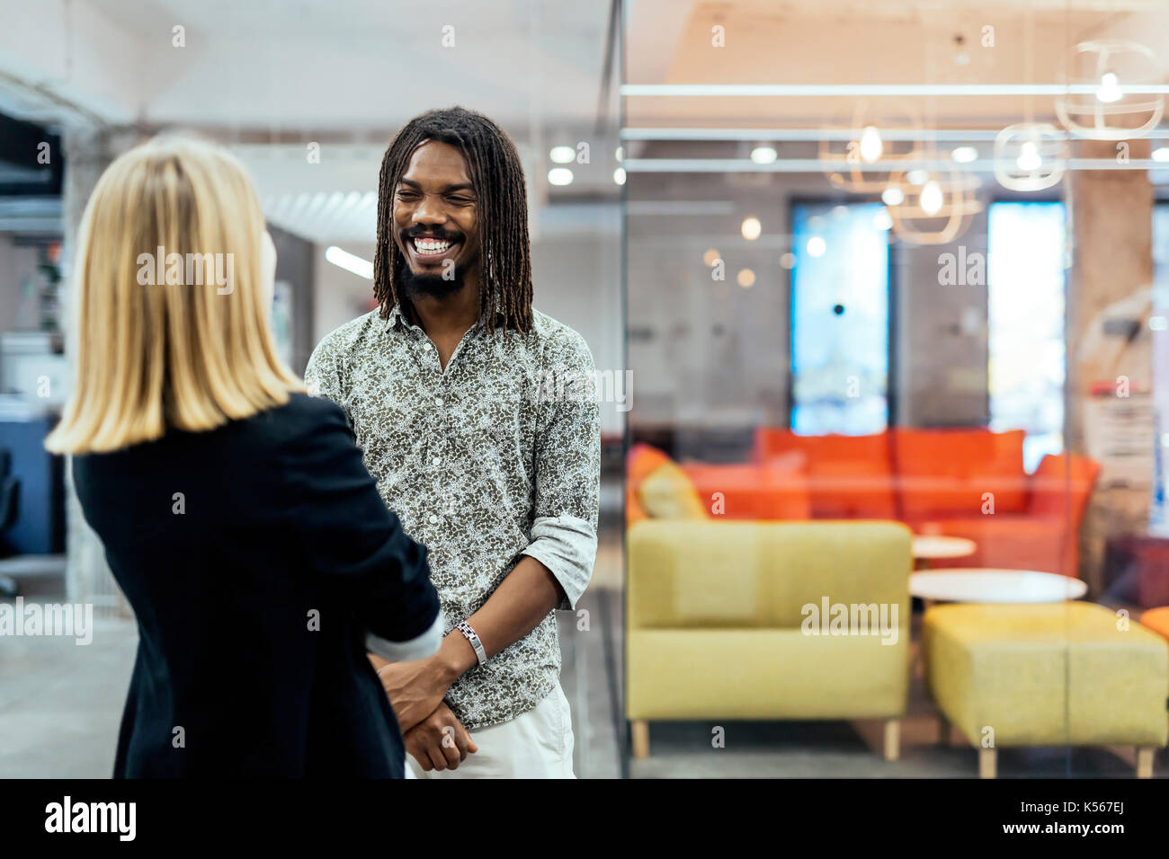 Colleagues smiling and talking Stock Photo - Alamy
