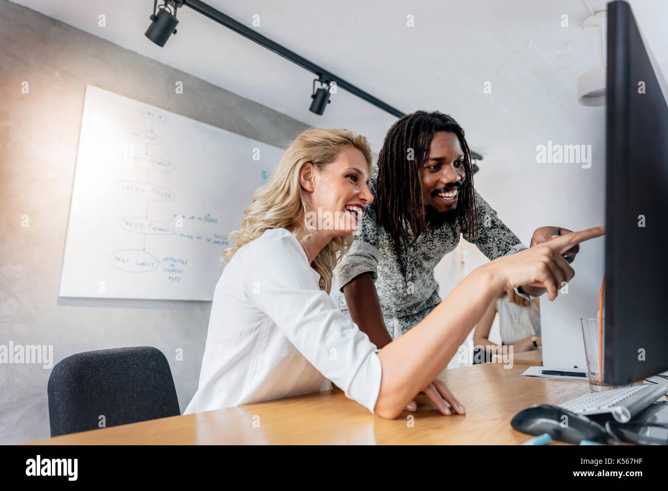 Man pointing at screen of desktop Stock Photo - Alamy
