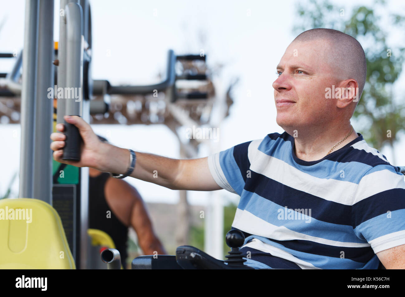Disabled man working out with trainer Stock Photo - Alamy
