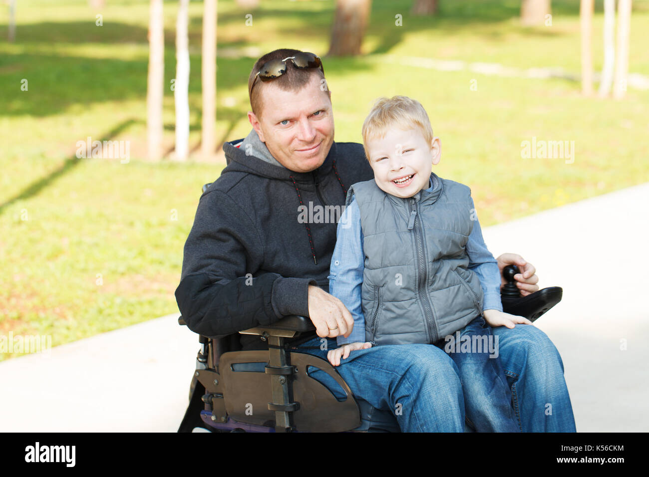 Disabled Father play with his little son Stock Photo - Alamy