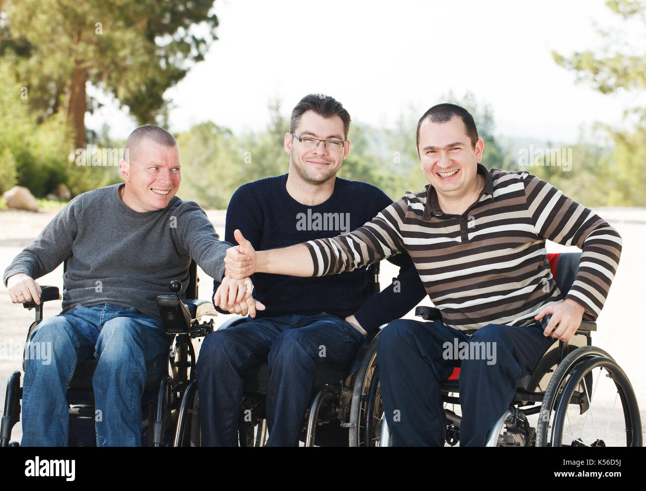 Disabled Happy friends with thumbs up Stock Photo - Alamy