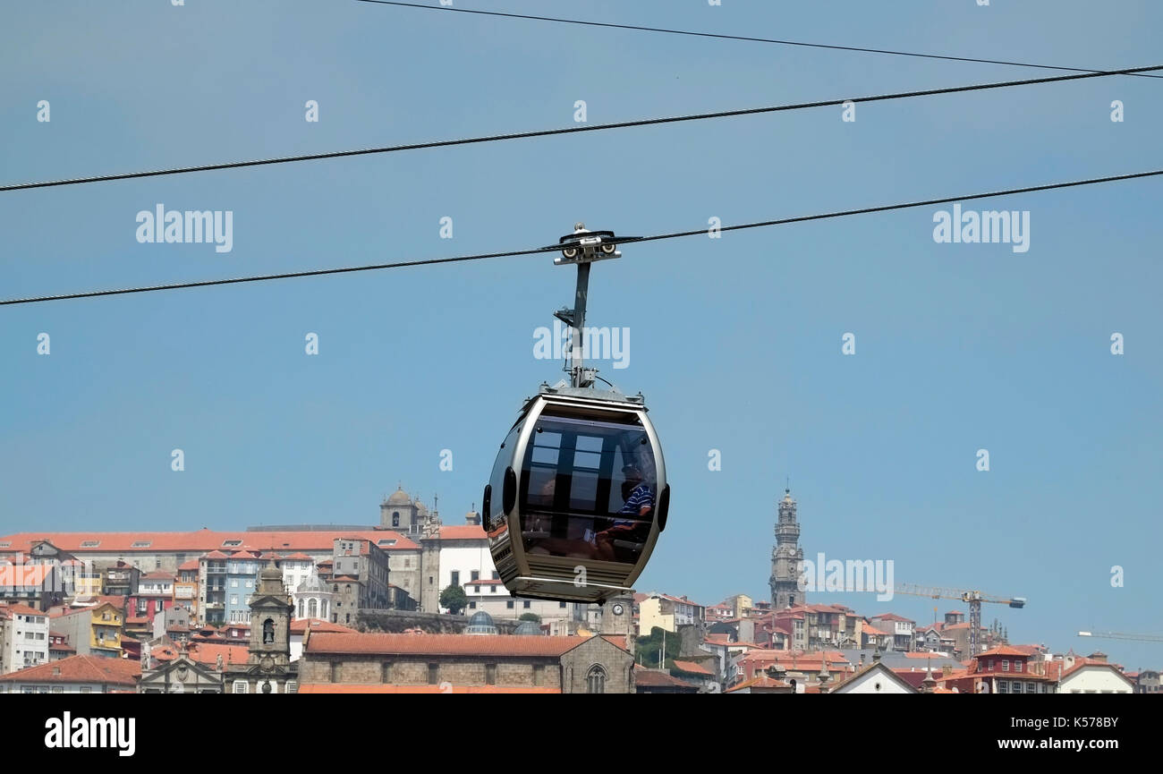 Tourists ride in gondolas on the Teleferico de Gaia cable car above the ...