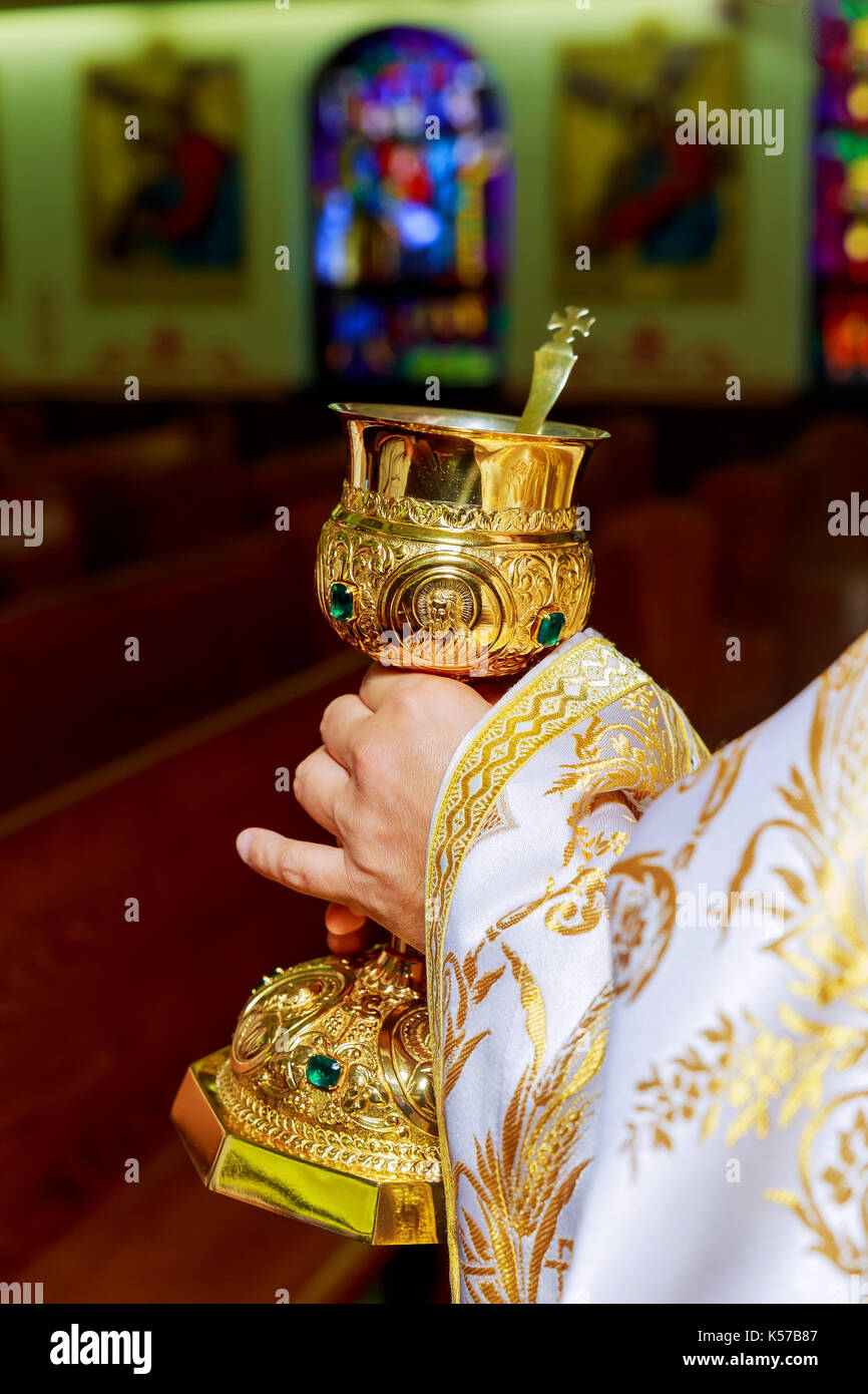 catholic priest with chalice cup during consecration ceremony church ...