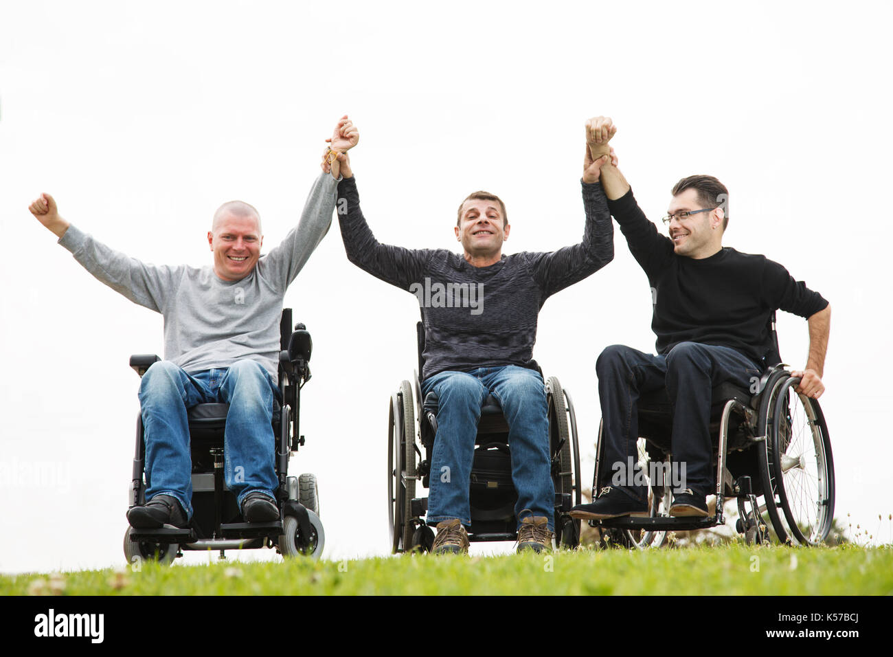 Disabled Happy friends with hands up Stock Photo - Alamy