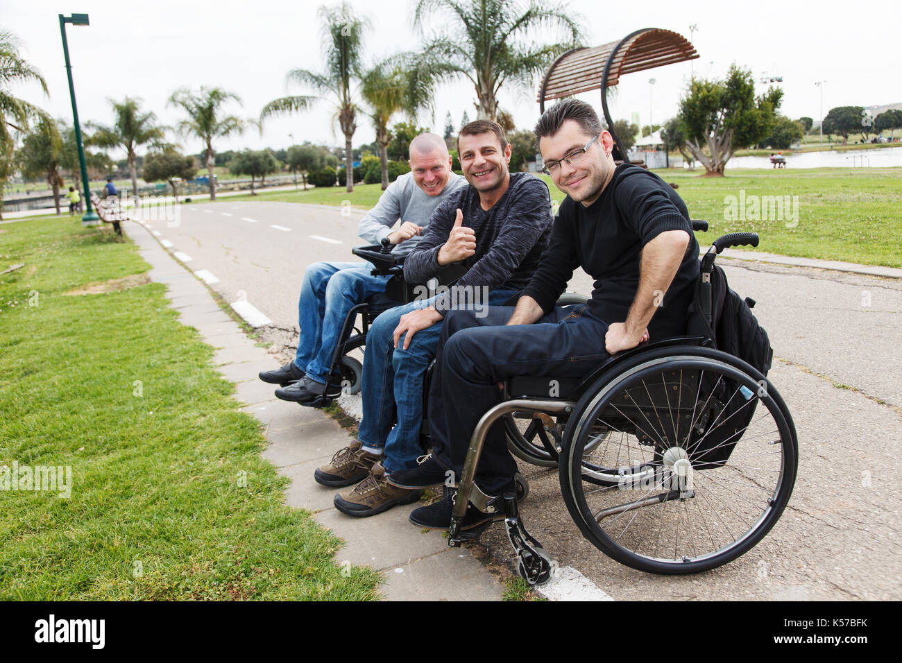 Disabled Happy friends with thumbs up Stock Photo - Alamy