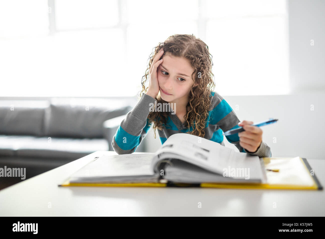 girl of 9 years in a school uniform homework Stock Photo - Alamy