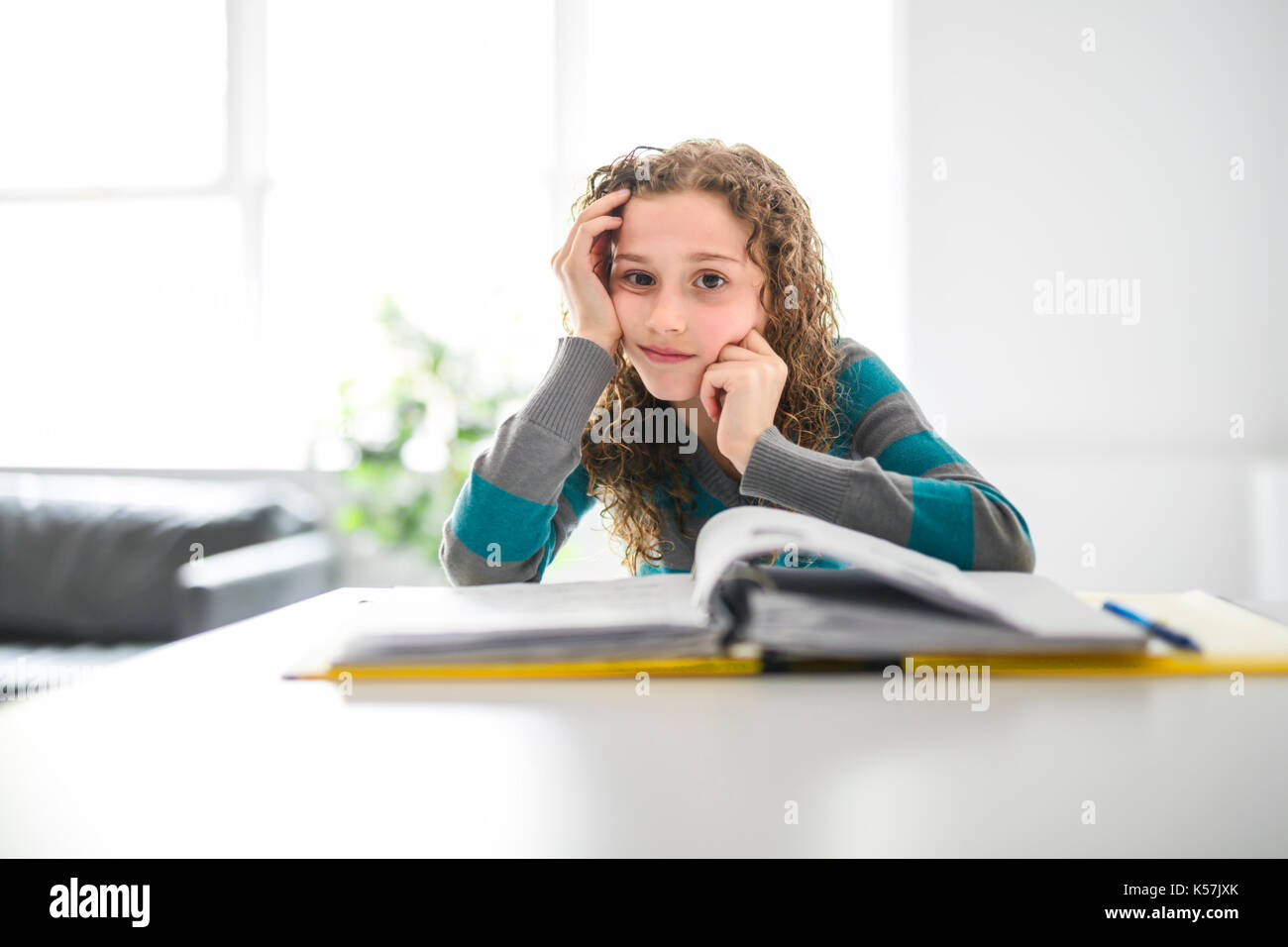 girl of 9 years in a school uniform homework Stock Photo - Alamy