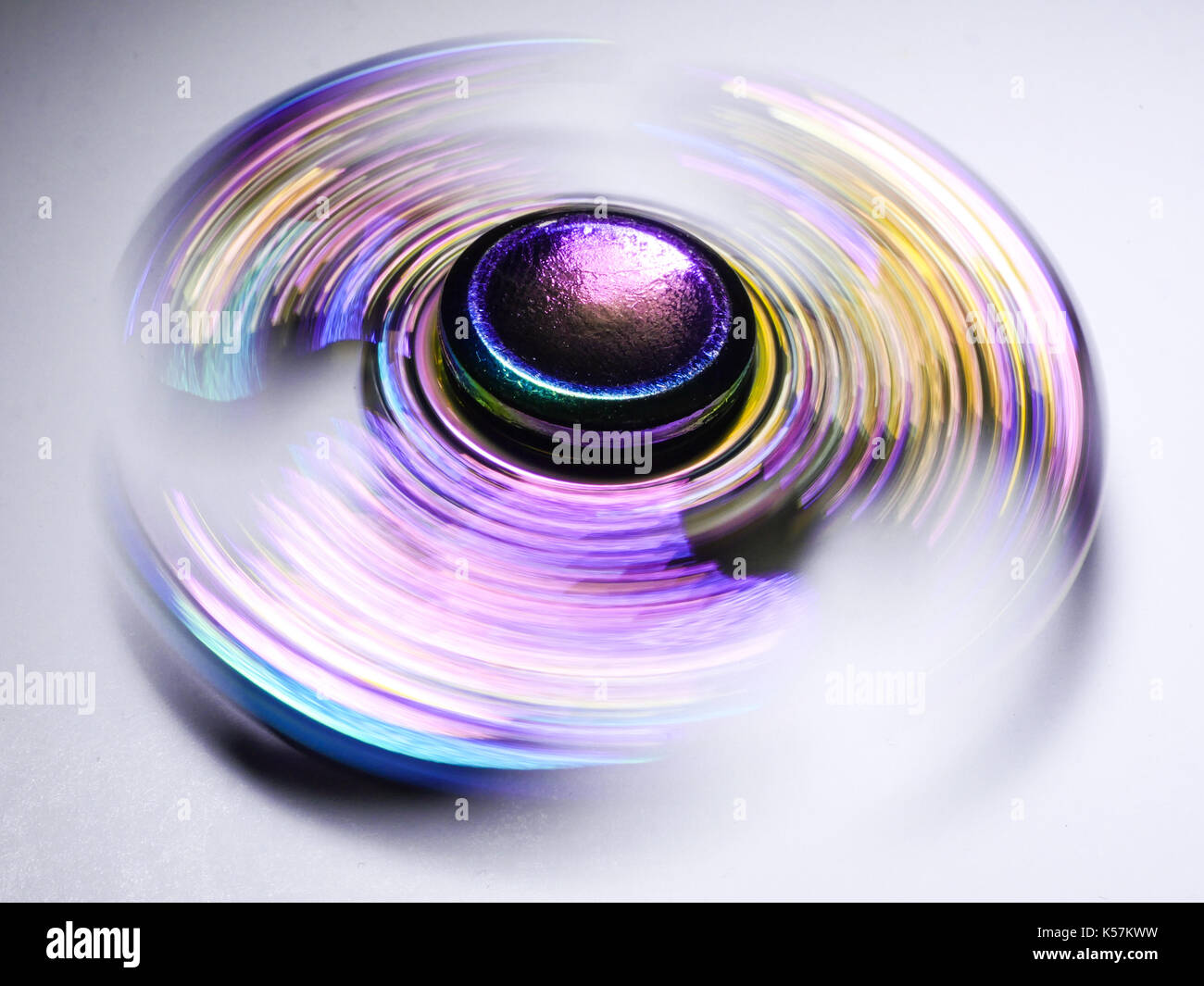Metallic spinning toy rotating Stock Photo - Alamy
