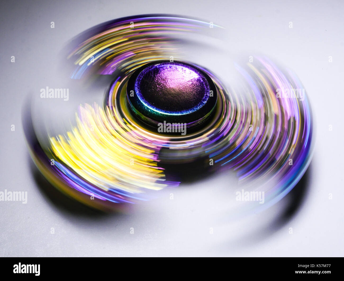 Metallic spinning toy rotating Stock Photo - Alamy