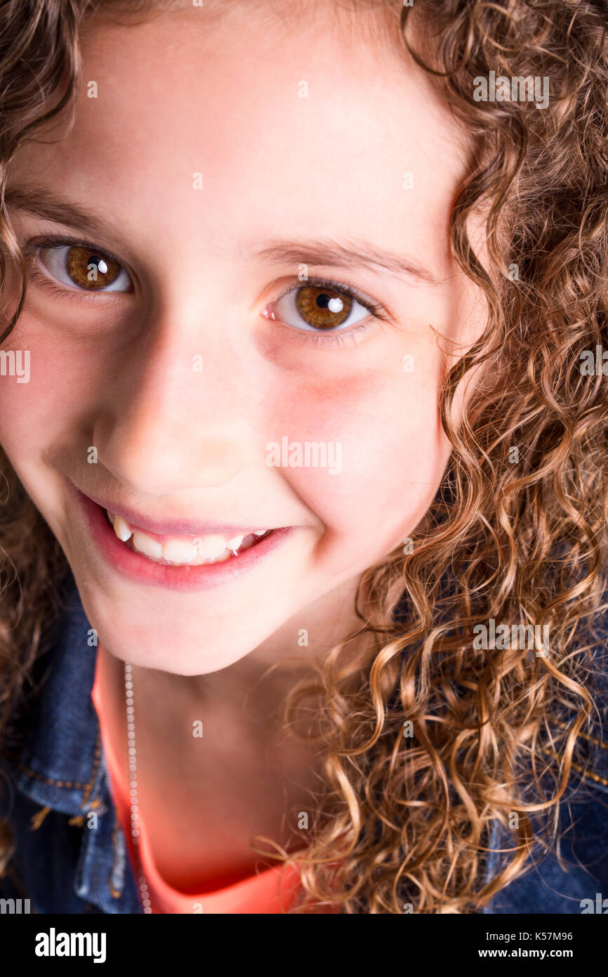 Portrait Of Happy Smiling Confident 9 Years Old Girl With Curly Hair