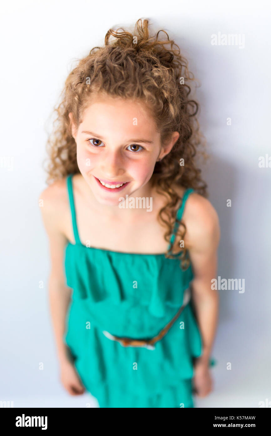 Portrait of happy, smiling, confident 9 years old girl with curly hair ...