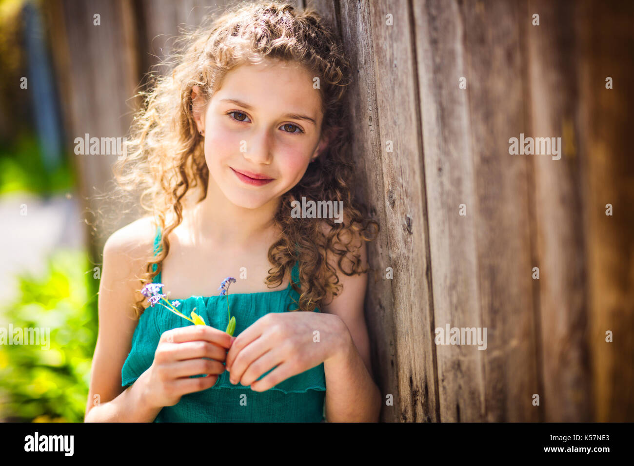 happy 9 years old girl on summer blow flower Stock Photo - Alamy