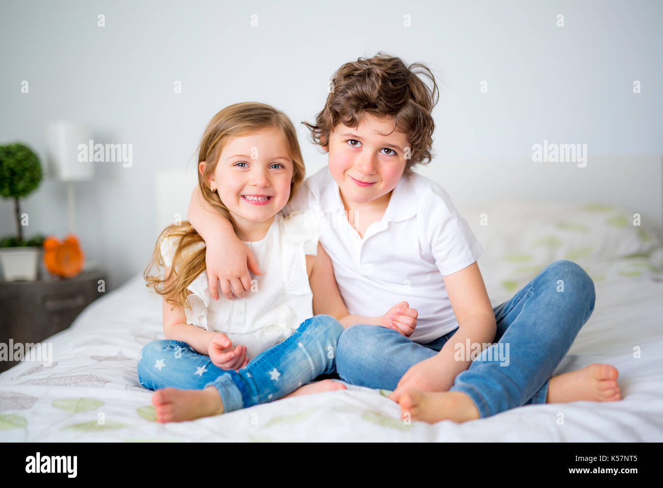 Brother And Sister Relaxing Together In Bed Stock Photo - Alamy