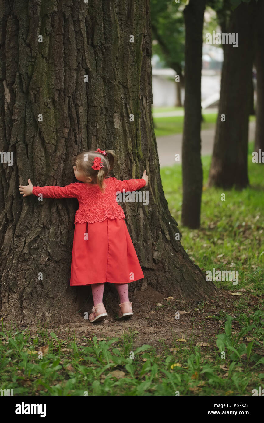 Child hug tree hi-res stock photography and images - Alamy