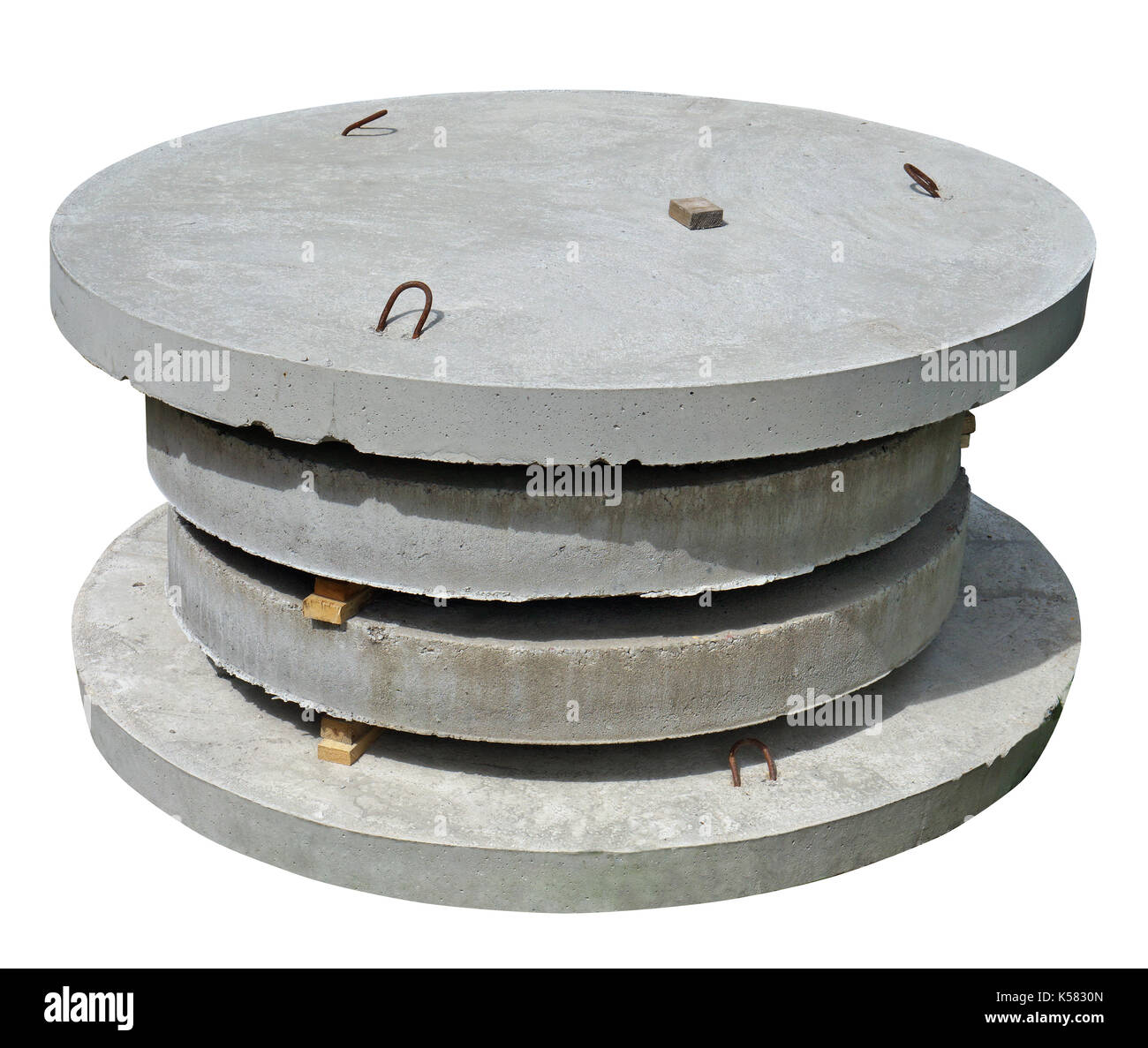 Stack of new industrial round concrete hatches for the sewerage system ...
