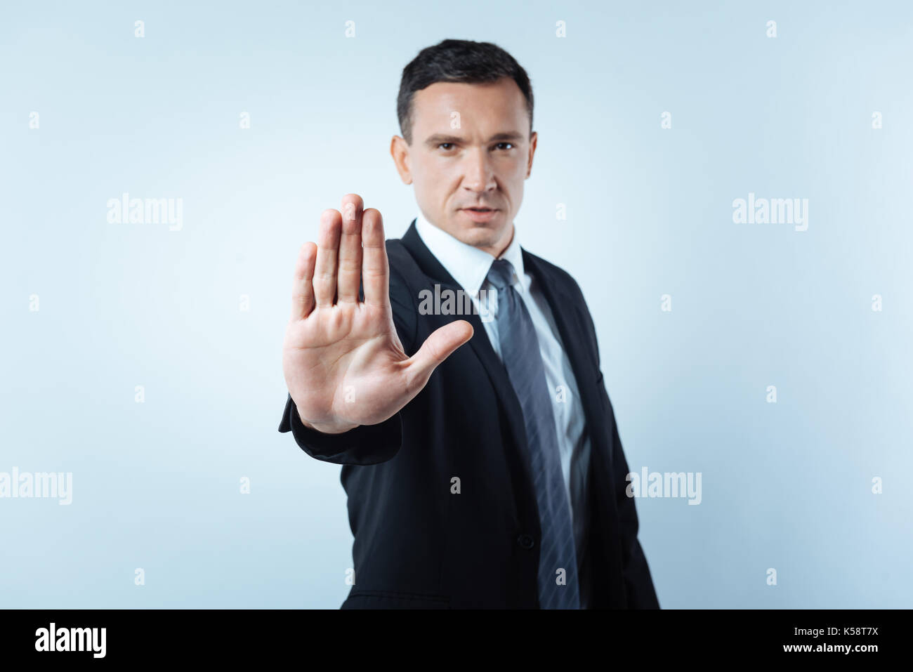 Serious handsome man showing his palm Stock Photo - Alamy