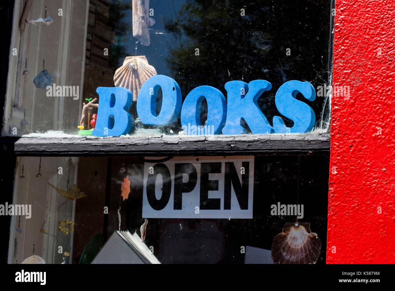 Open bookshop sign through the window of an old book shop, Ireland ...