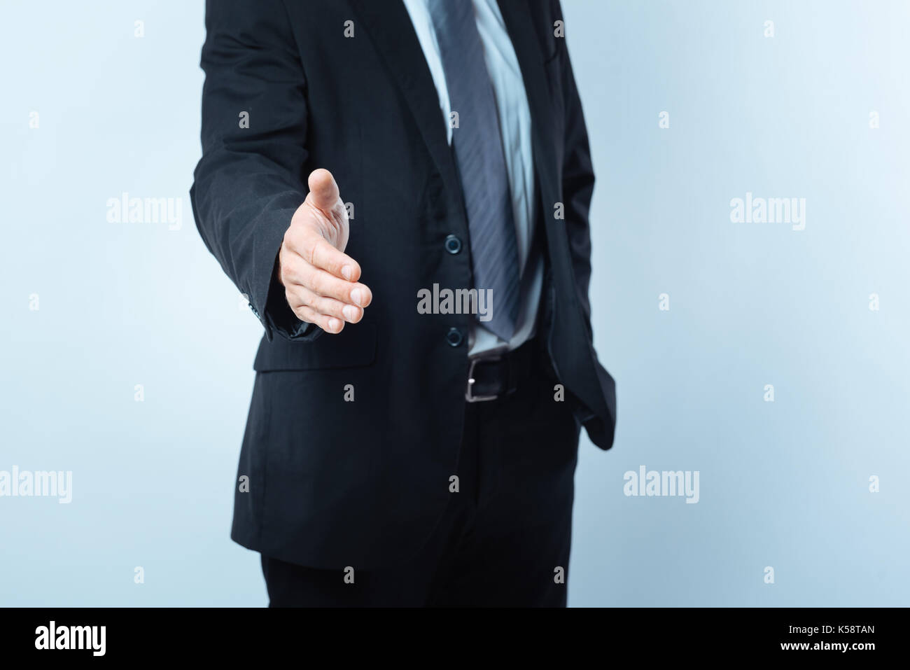 Nice pleasant man showing his hand Stock Photo - Alamy