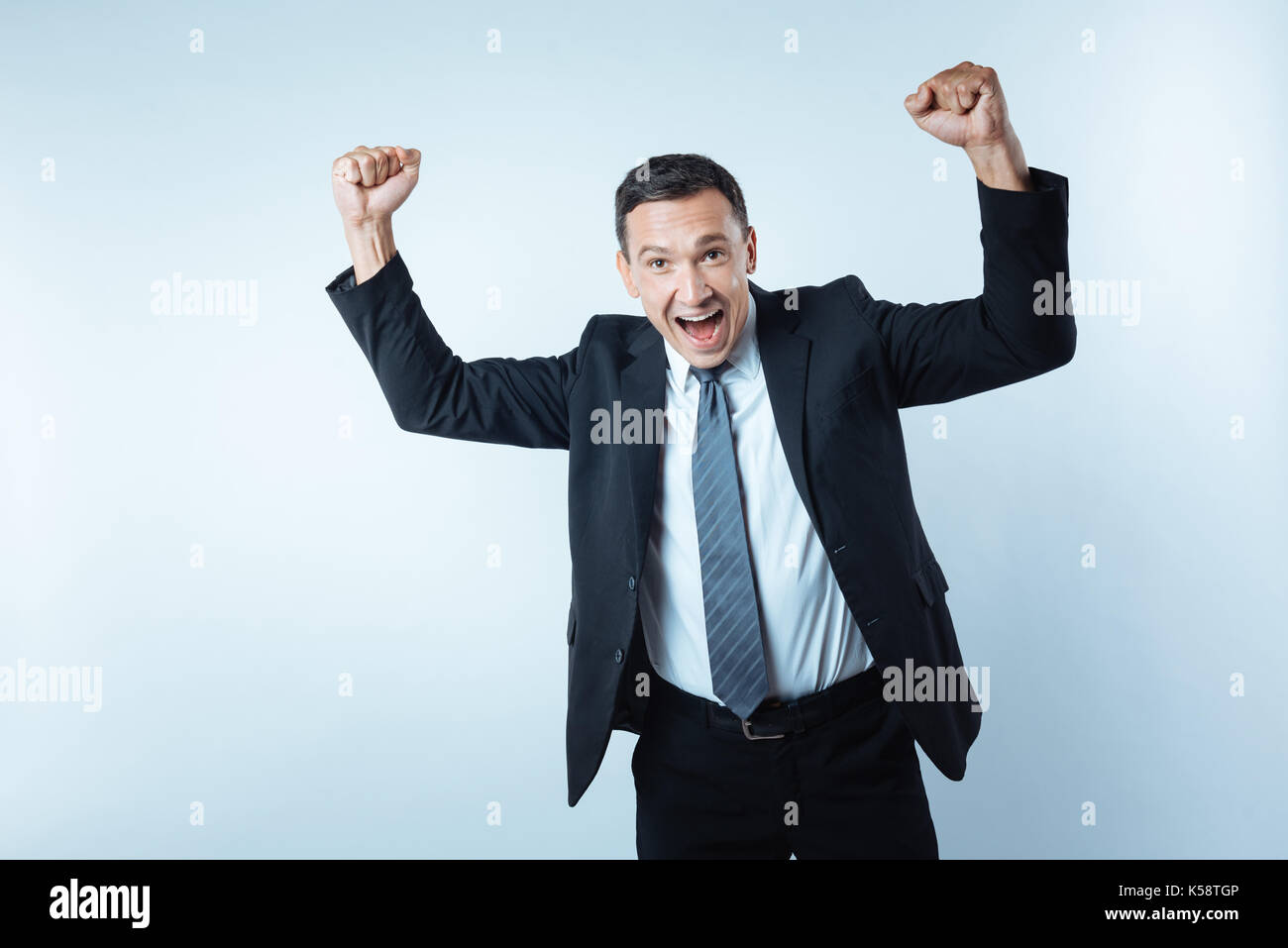 Cheerful delighted man showing his happiness Stock Photo - Alamy