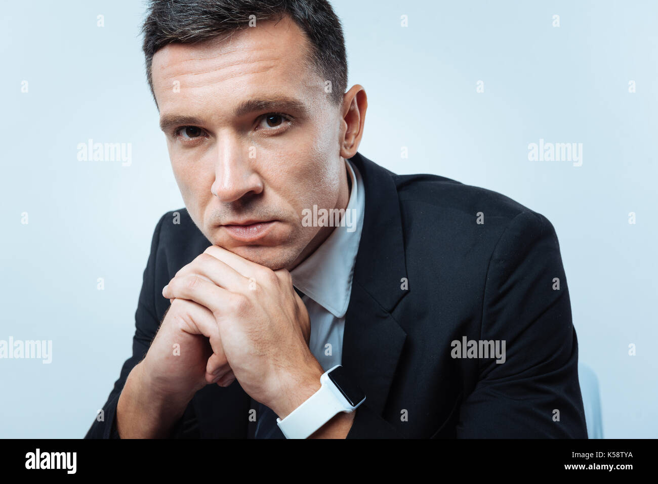Handsome serious entrepreneur looking at you Stock Photo - Alamy