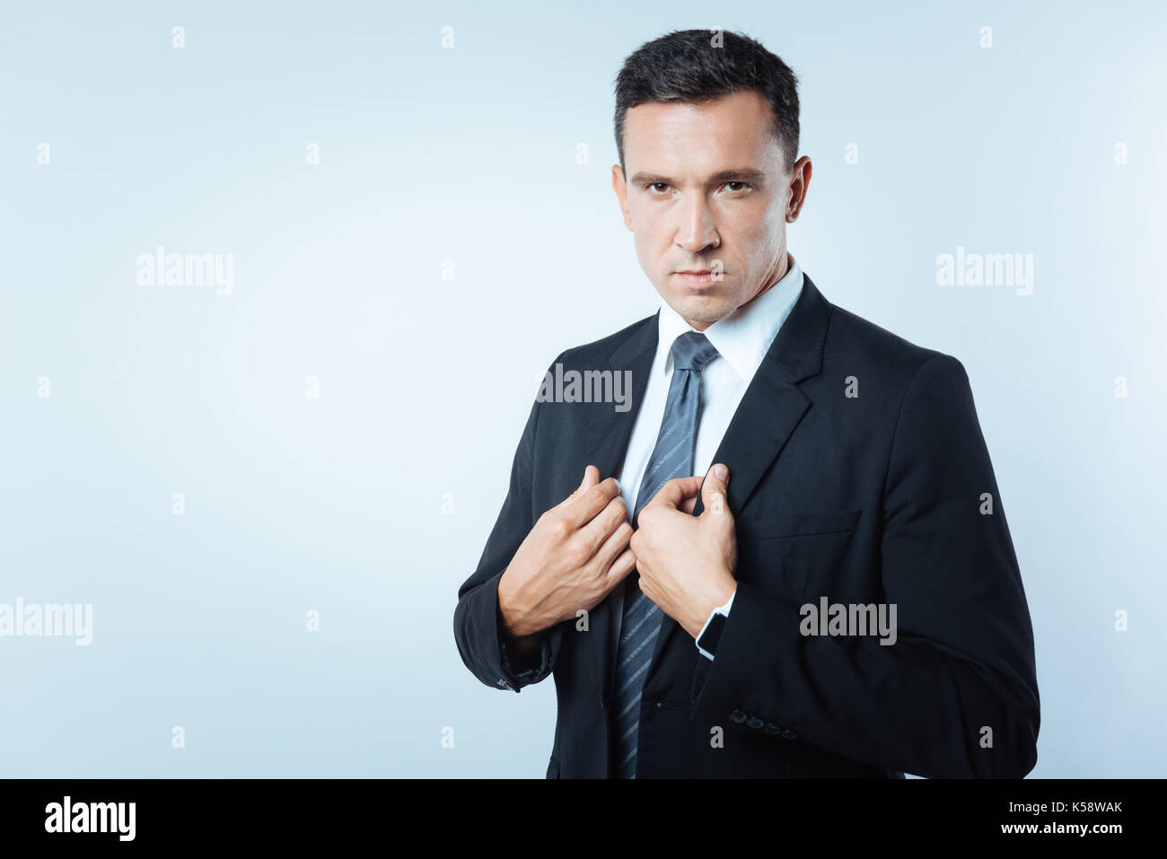 Good looking confident man looking at you Stock Photo - Alamy