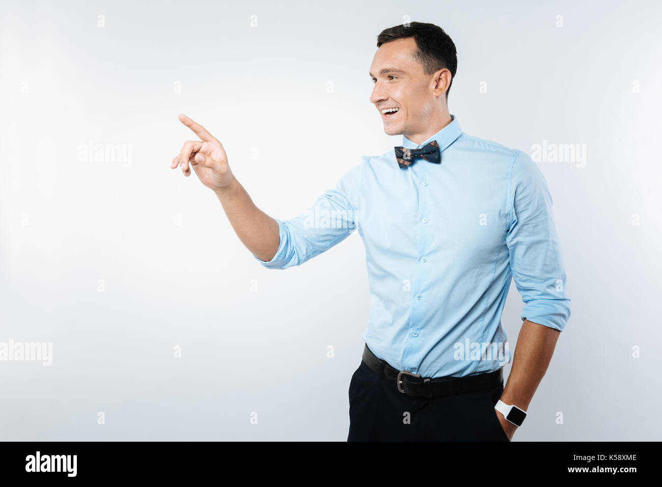 Positive cheerful man pointing with his finger Stock Photo - Alamy