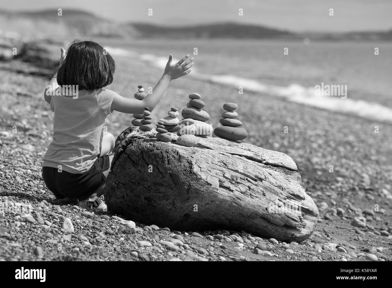 Child stacking rocks hi-res stock photography and images - Alamy